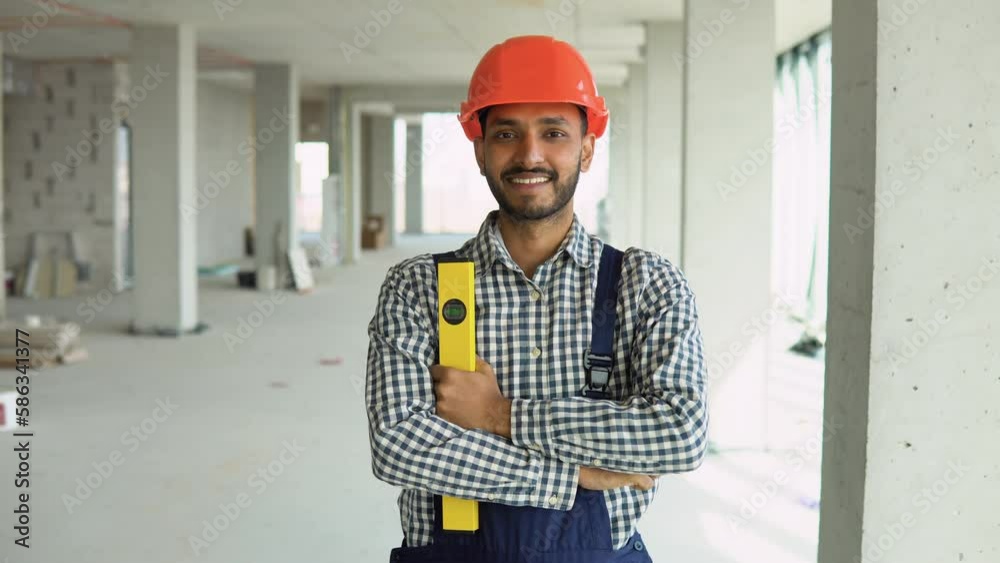 Portrait of Indian worker builder in uniform wearing a safety helmet ...