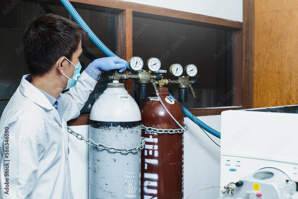 Scientist man control gas of instrumental Liquid Chromatography Mass ...