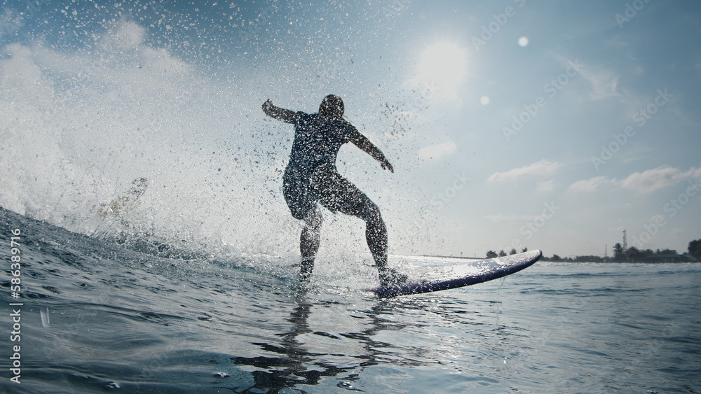 Girl surfer rides the wave. Woman surfs the ocean wave in the Maldives ...