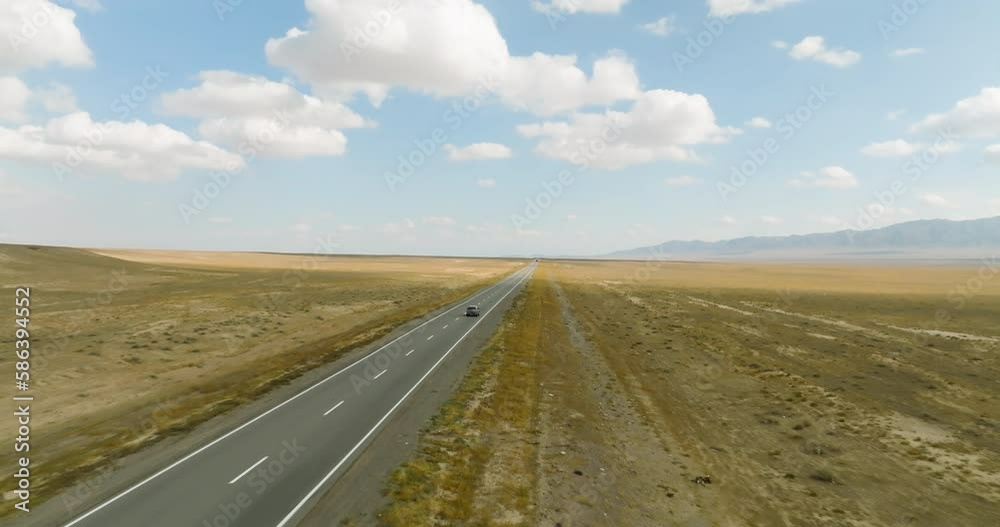 One gray silver crossover SUV car driving alone, travel on empty ...