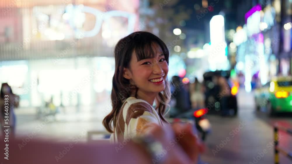 Point of view young Asian woman holding hands with boyfriends walking ...