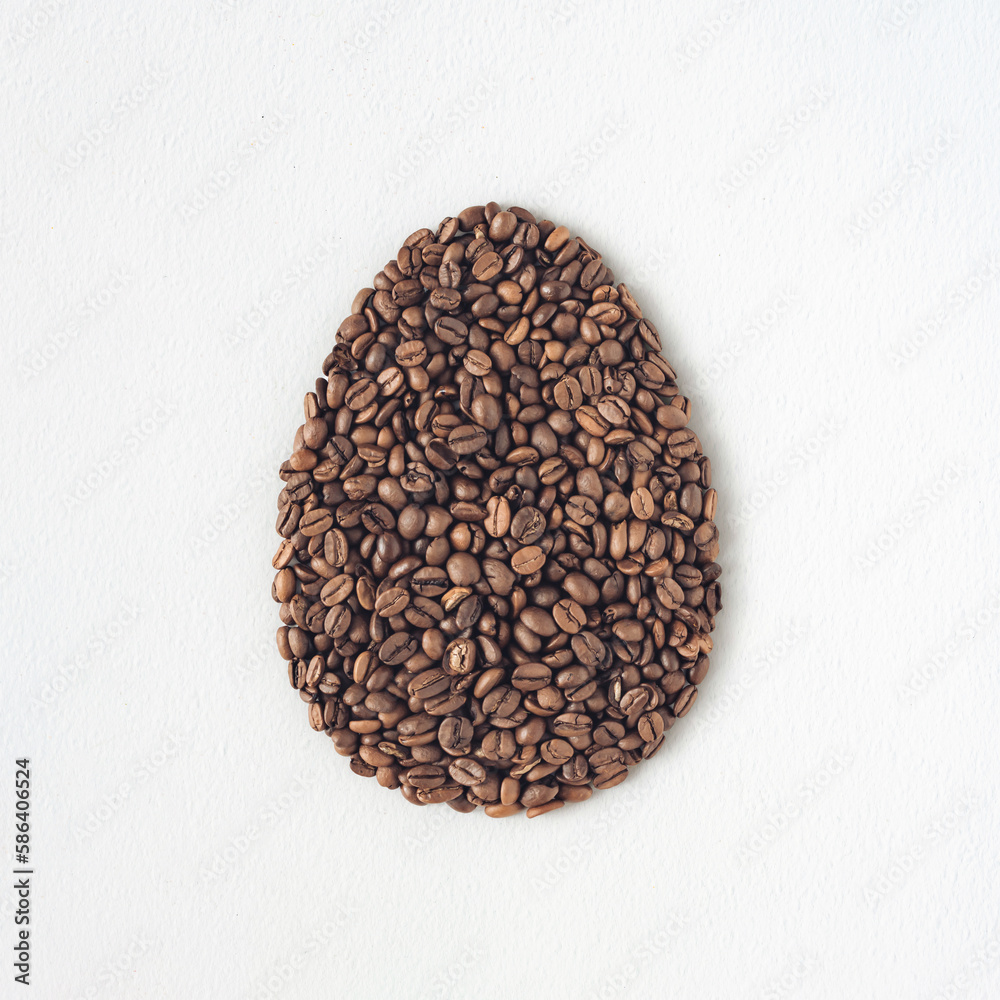 Trendy composition with easter egg shape made of coffee roasted beans ...