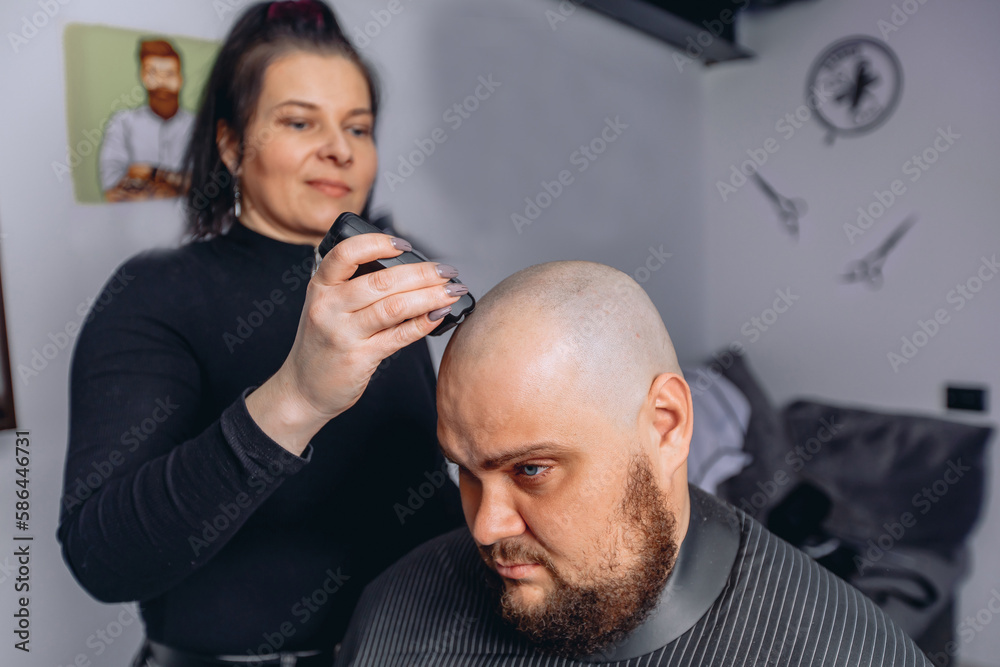 The girl is holding a special clipper in her hands and completely ...