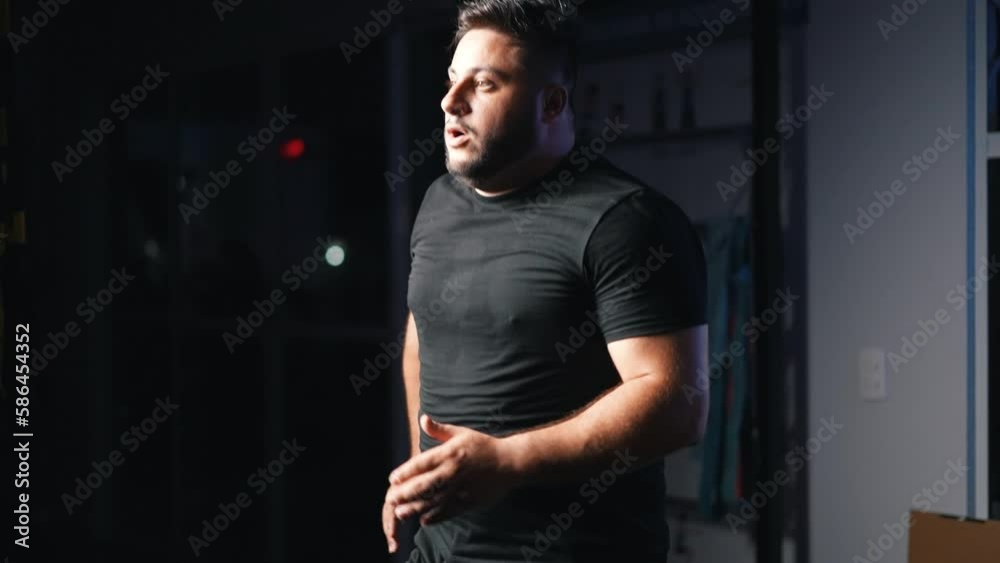 Strong man running in place as a cardio exercise for daily workout in a ...