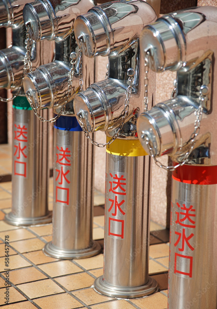 Metal pipe of fire hydrant leading to Japan building Stock Photo ...