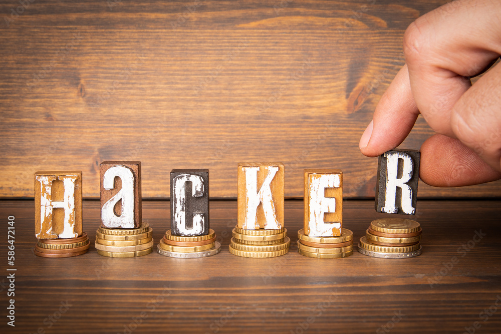 Hacker Concept. Alphabet blocks and change on wood texture background ...