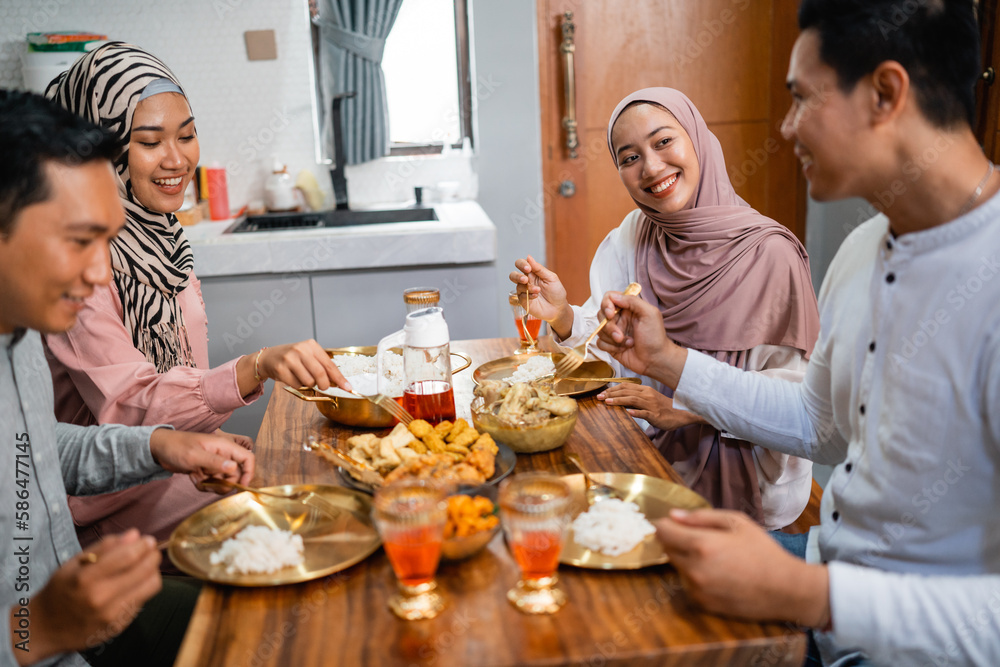 happy muslim friends having iftar dinner together at home Stock Photo ...