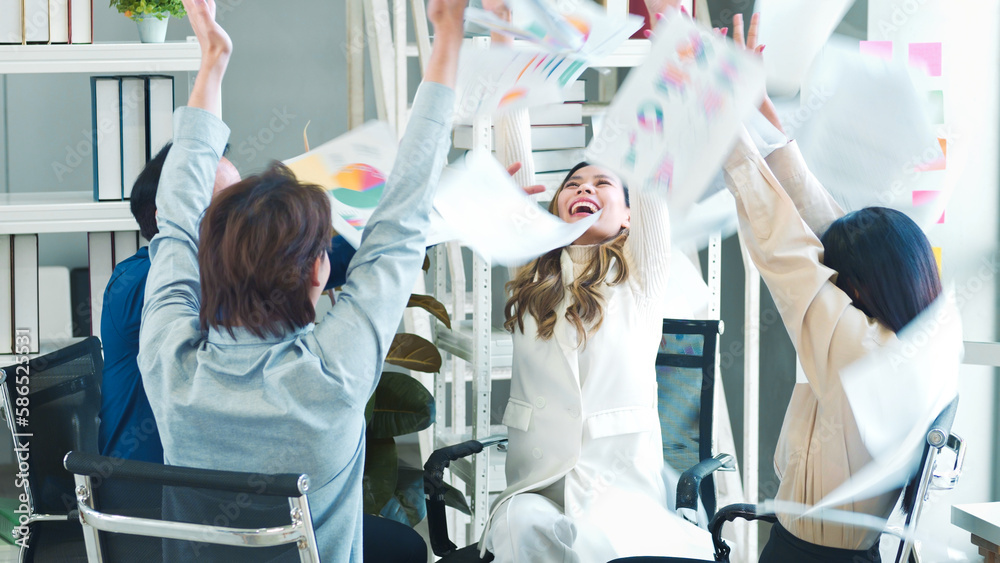 Asian young business people are stacking hands, cheering, throwing ...
