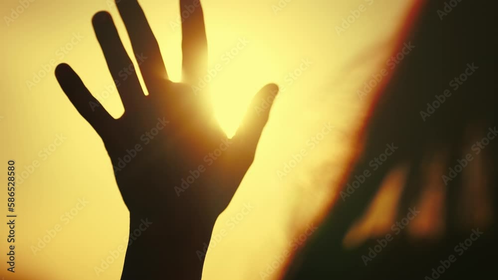 hand of happy girl at sunset with glittering golden light. sunset ...