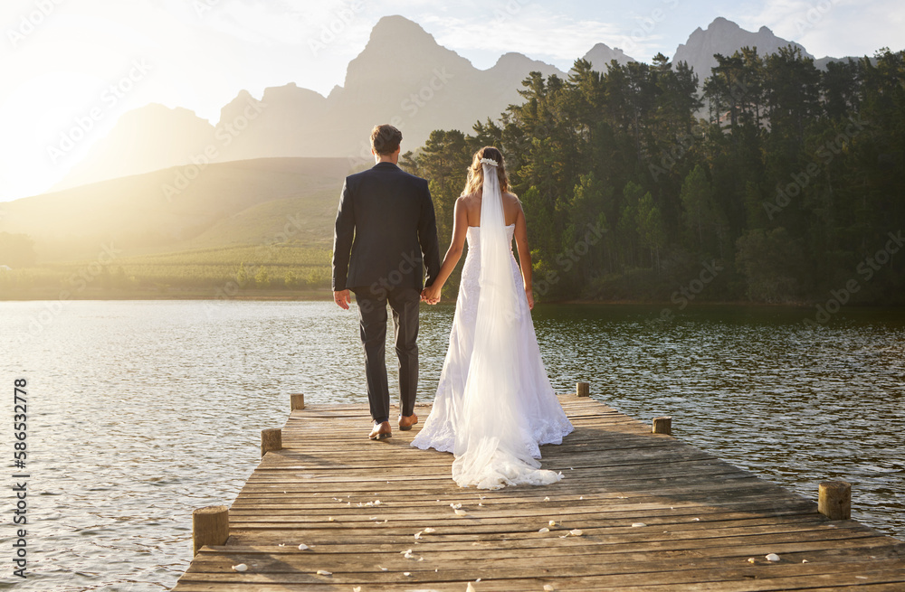 Love, wedding and back of couple by a lake standing, bonding and ...