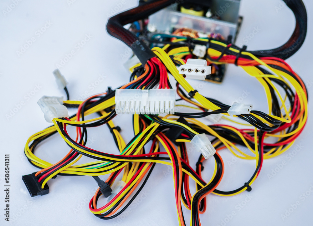 Multi-colored computer wires with white connectors on a white ...