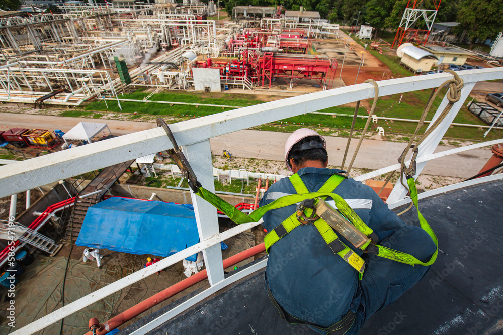 Male worker wearing safety first harness and safety lone working at ...