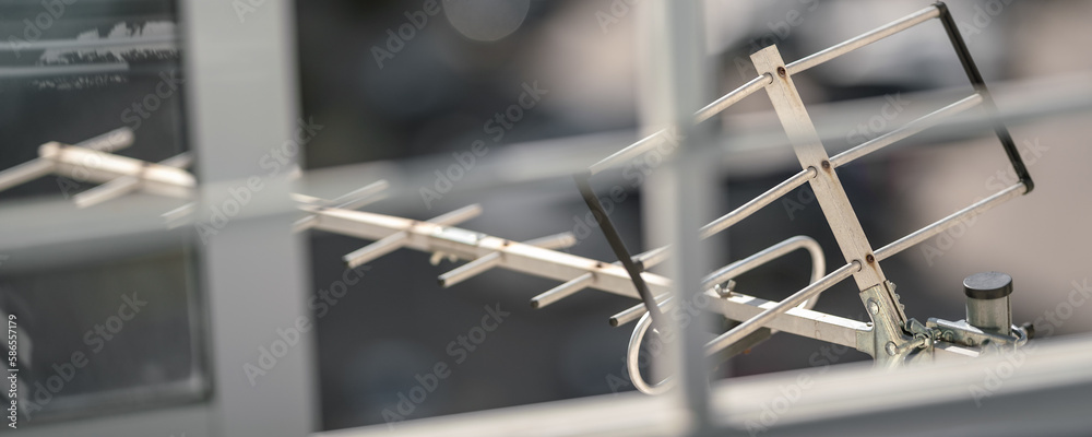 Metal vintage tv antenna mounted on building rooftop outdoor ...
