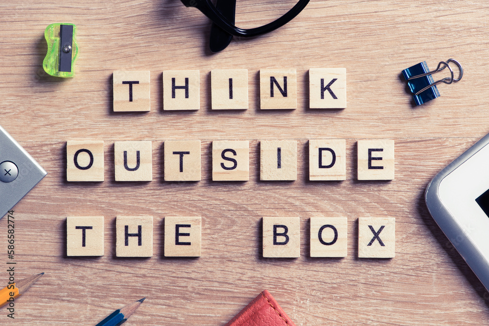 Game elements on wooden table spelling brainstorming and creative ...