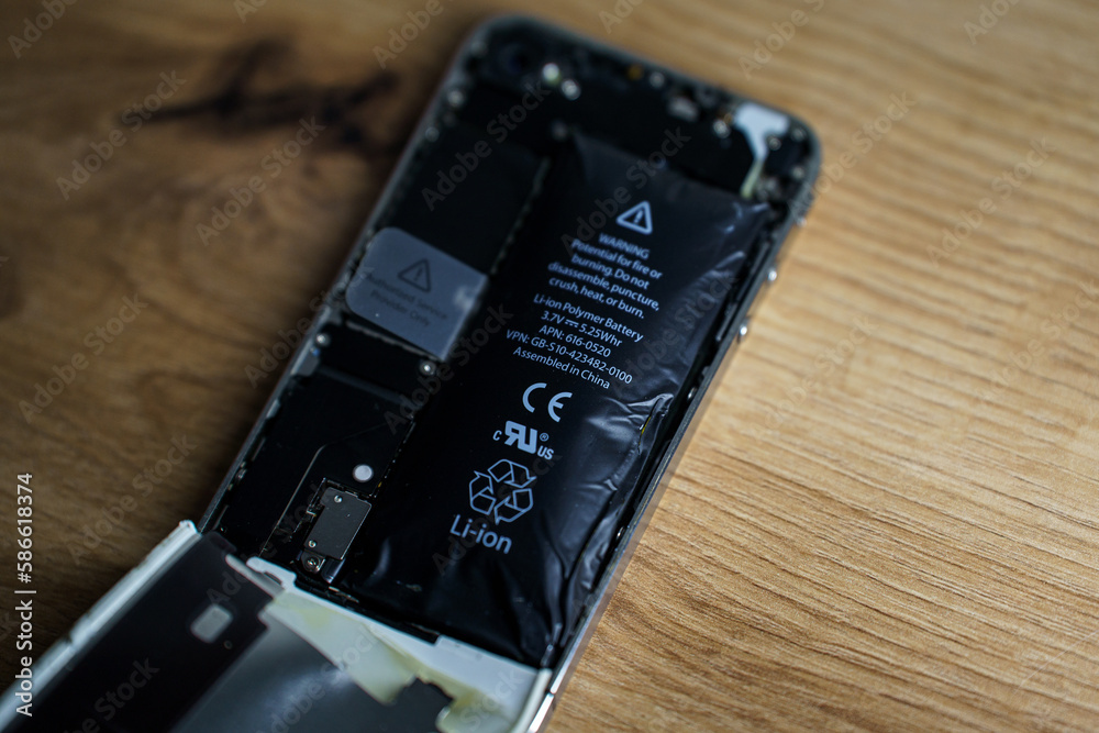 Foto de Iphone with exploded Lithium-ion battery. Li-ion swollen ...