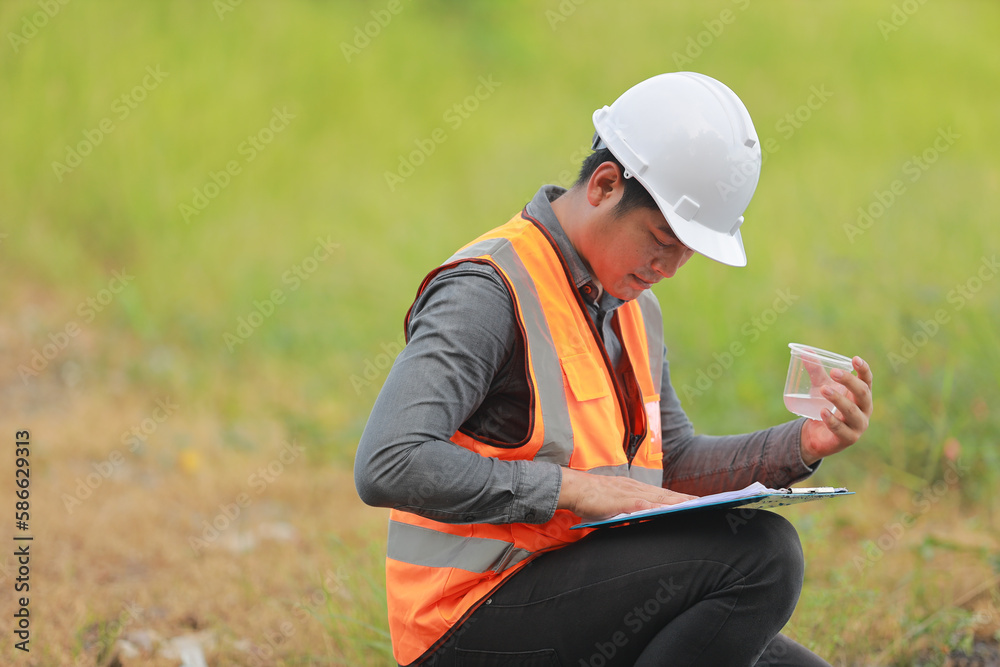 Environmental engineers work at water source to check for contaminants ...