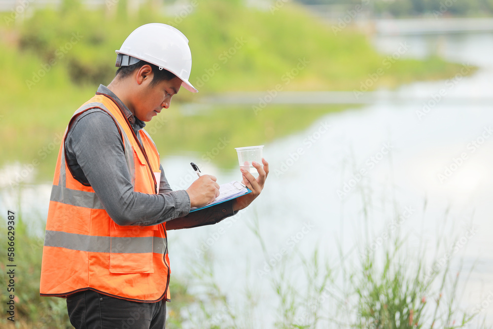Environmental engineers work at water source to check for contaminants ...