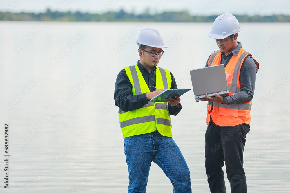 Environmental engineers work at water source to check for contaminants ...