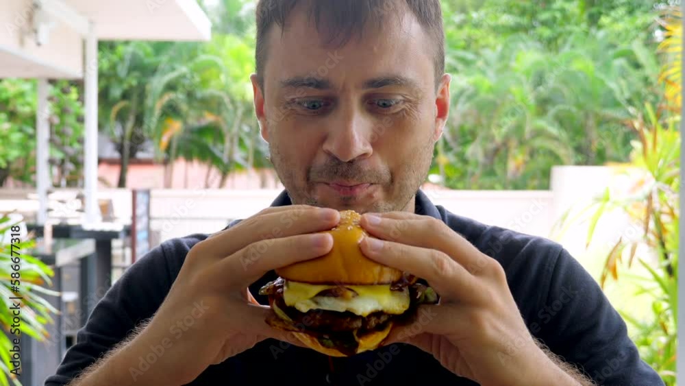 Close-up of man with funny face, licking his lips preparing to eat ...