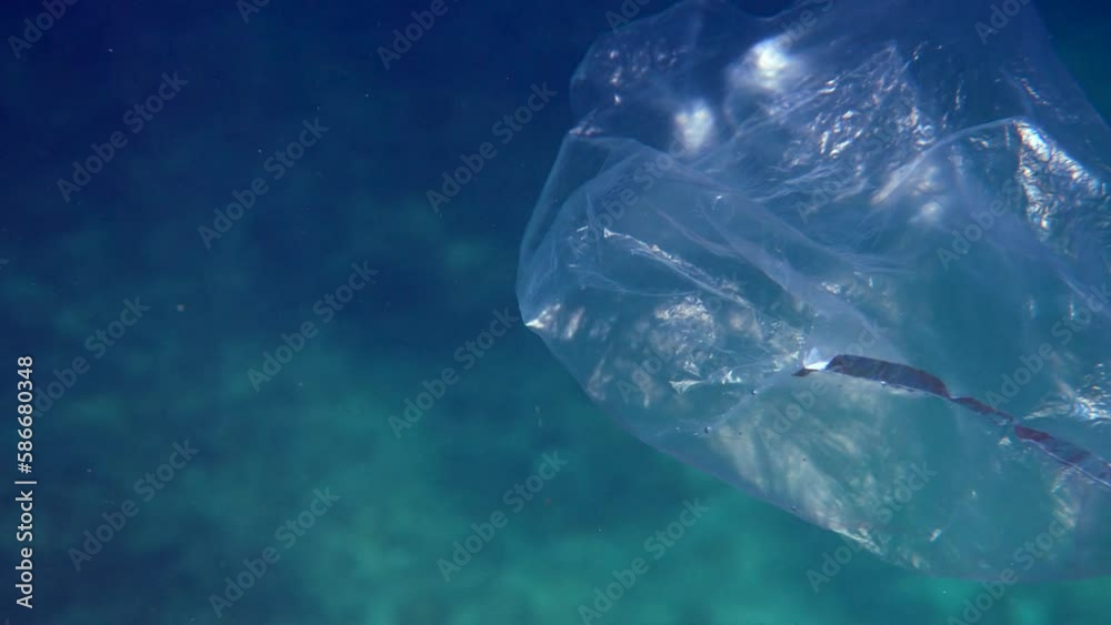 Plastic waste in ocean, underwater shot of a plastic bag drifting in ...