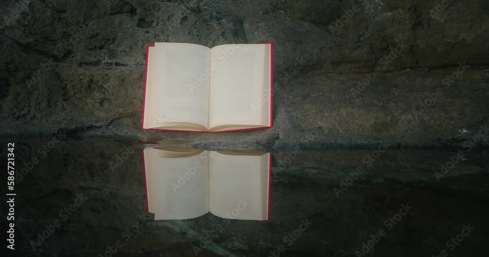 Crystal reflection of an open book in the water. Knowlegde wisdom ...