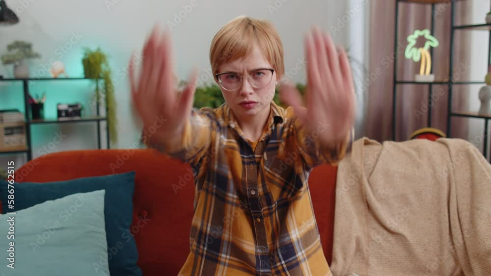 Stop gesture. Portrait of angry young woman say No hold palm folded ...