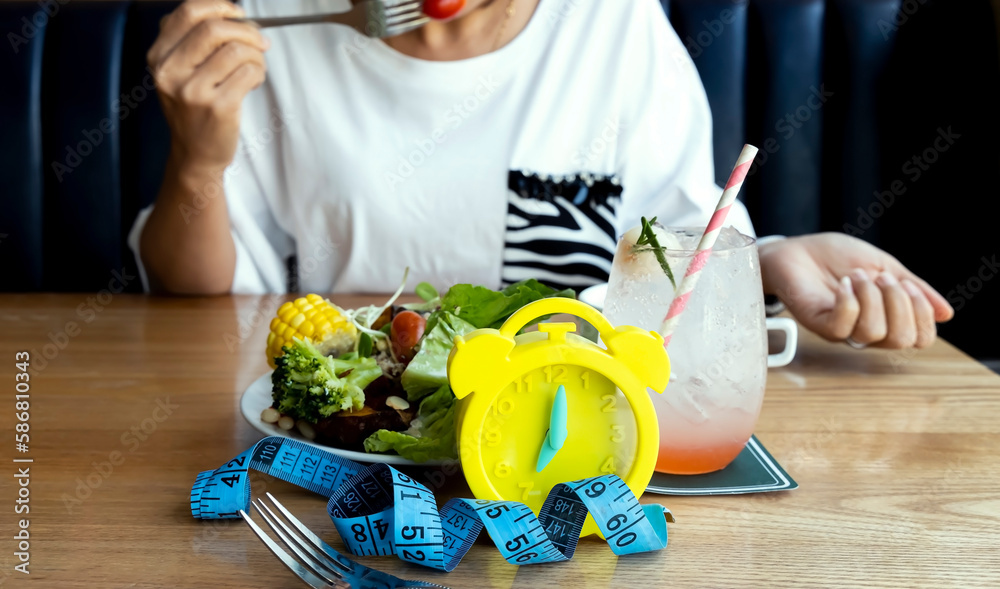 Yellow alarm clock with Intermittent fasting eight hour feeding window ...