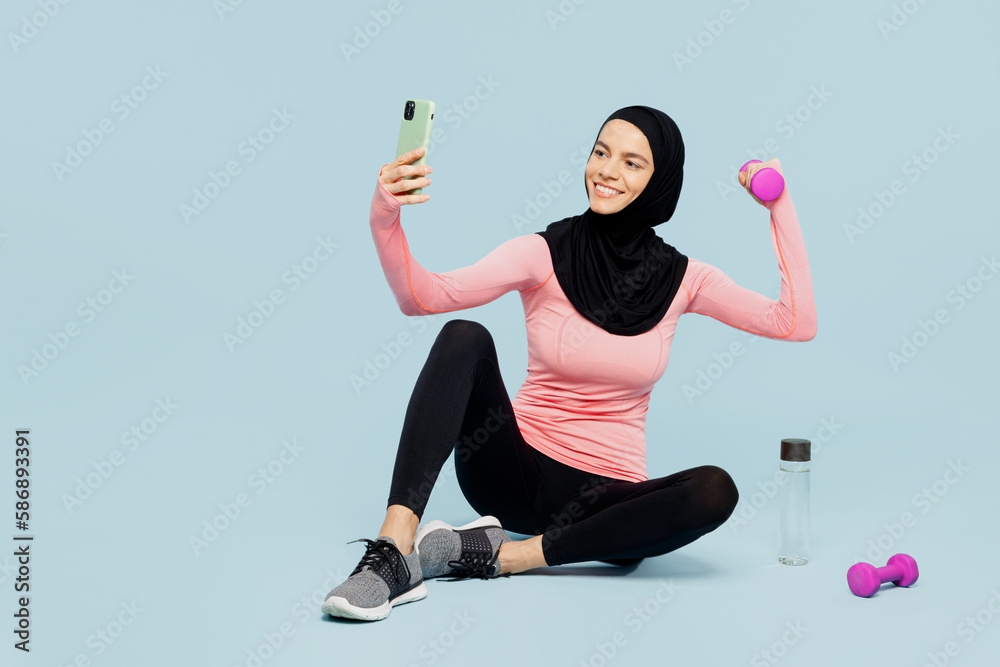 Full body young fitness trainer sporty woman wear pink abaya hijab ...