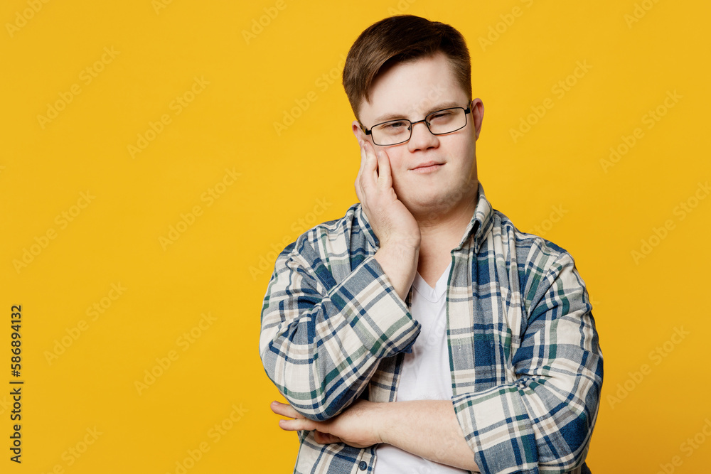 Young sad minded pensive man with down syndrome wearing glasses casual ...