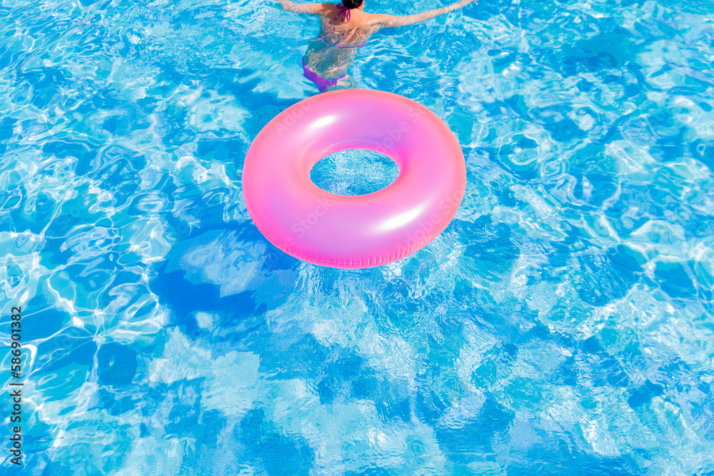 Inflatable life buoys in the pool of teenage girls in bikini and ...