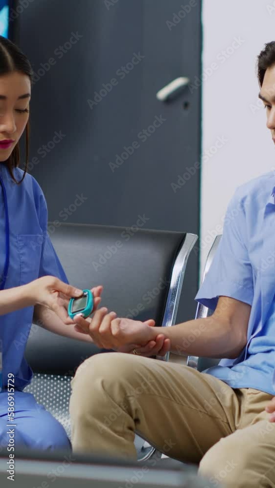 Vertical video: Nurse measuring insulin level and glucose in blood ...