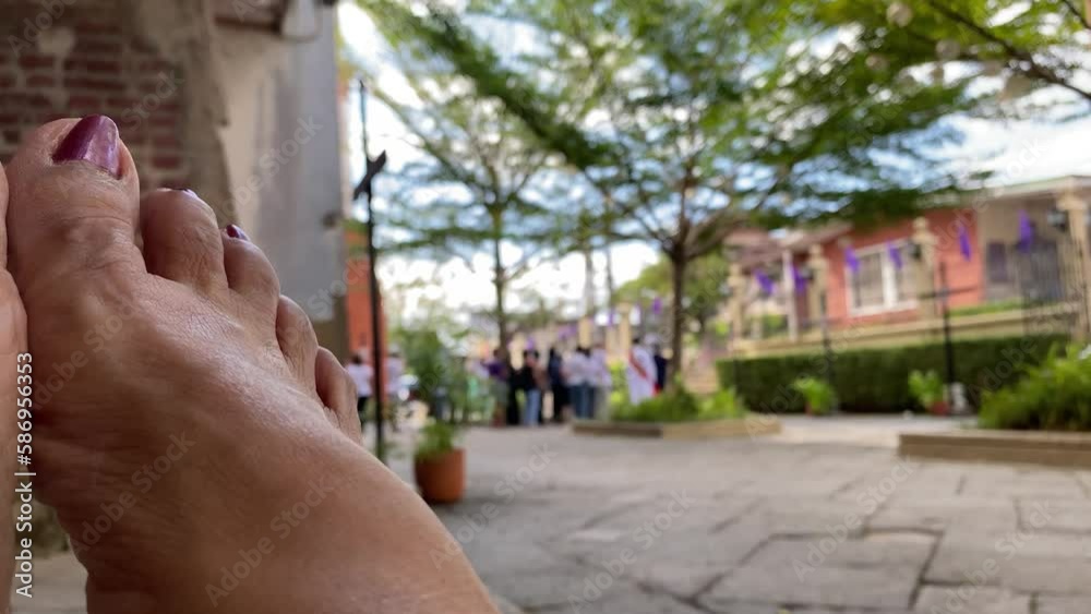Mature woman's feet obscure the view of Roman Catholic devotees who ...