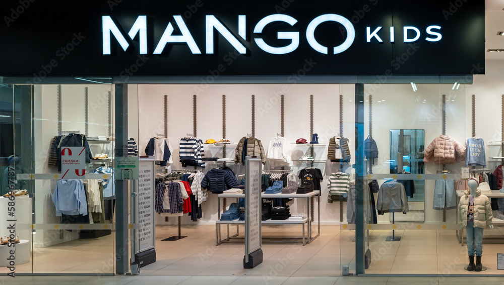MANGO KIDS clothing store in shopping center. Logo and view inside the ...