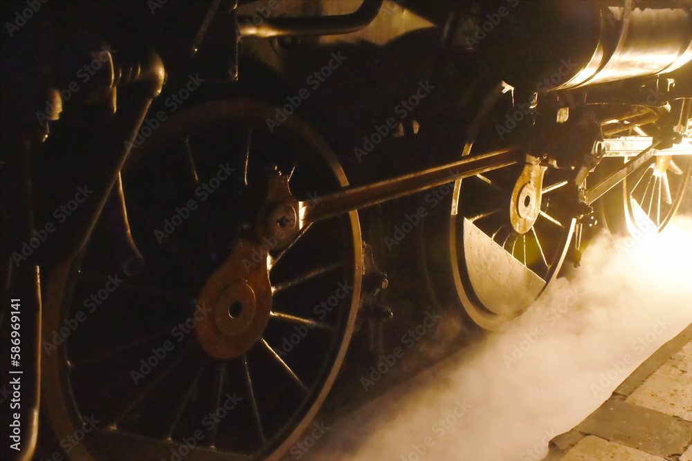 steam locomotive iron wheel with smoke floating on railway in night ...
