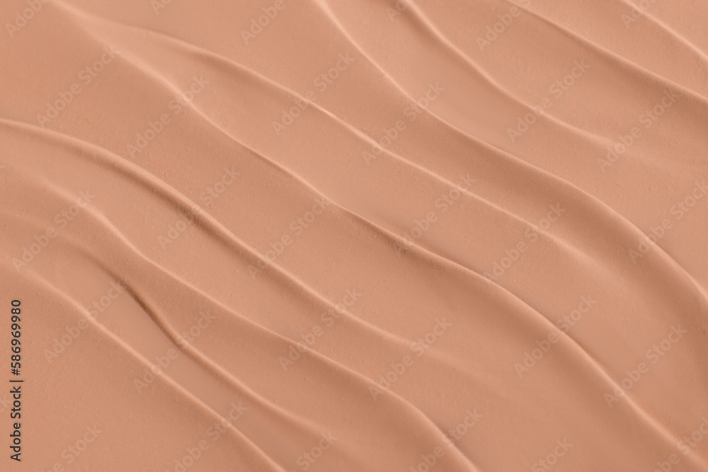 Smudged texture of liquid foundation smeared over background. Close-up ...