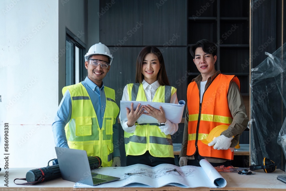 Team of happy confiden engineers wearing safety hard hat and vest ...
