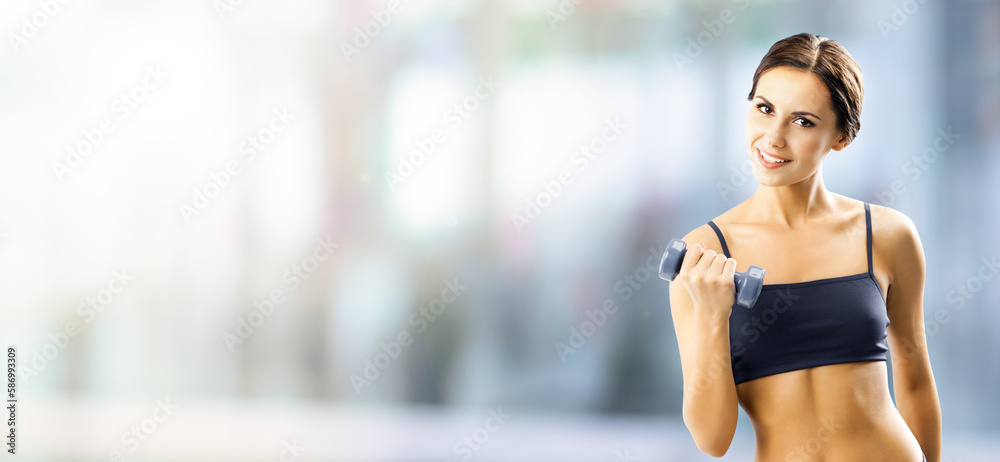 Portrait of happy smiling beautiful woman in fitness wear exercising ...