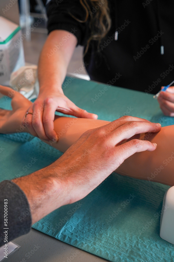 5th year medical students during an IV placement workshop. Students ...