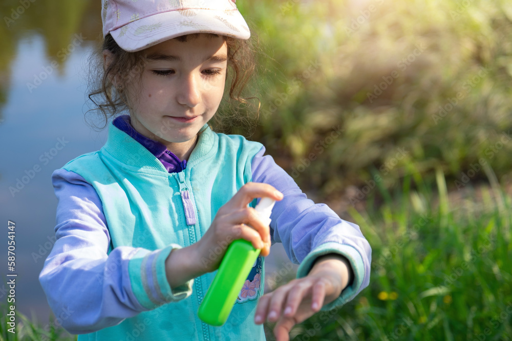 Girl uses a remedy for mosquitoes and biting insects in nature ...