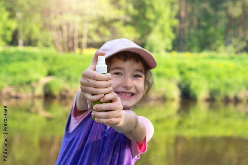 Girl uses a remedy for mosquitoes and biting insects in nature ...