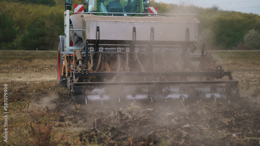 Tractor working in the field. Autumn tillage. Deep ripping with ...