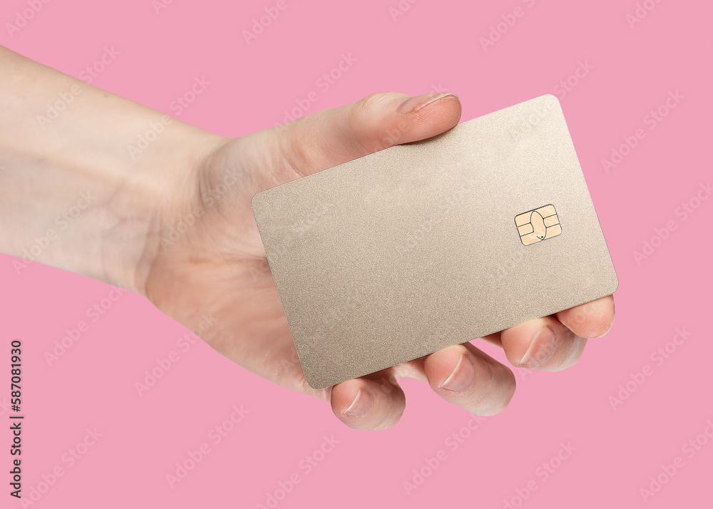 Bank credit card mock up in female hand on pink background. Blank clean ...