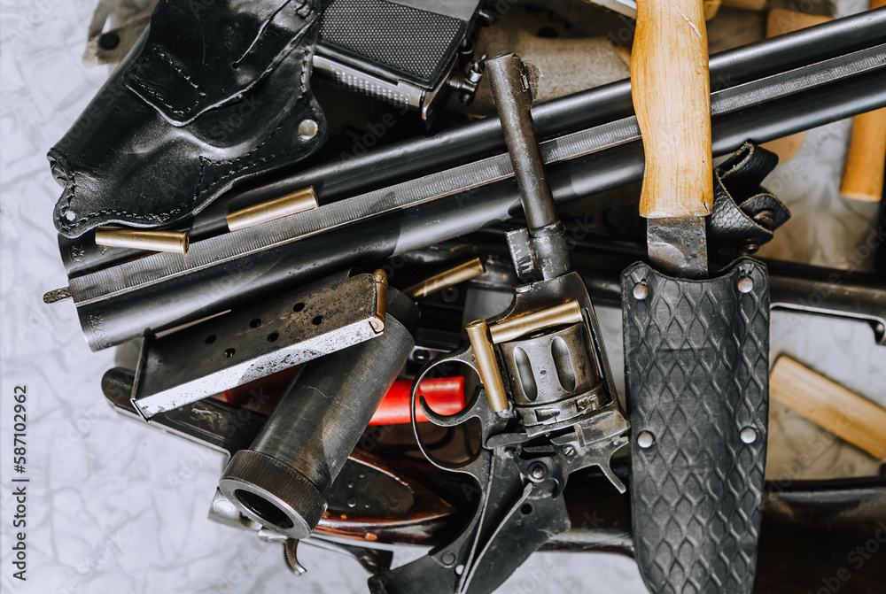 Old weapons of various calibers, a rifle, a metal revolver with ...