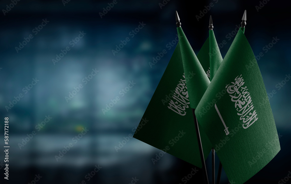 Small flags of the Saudi Arabia on an abstract blurry background Stock ...