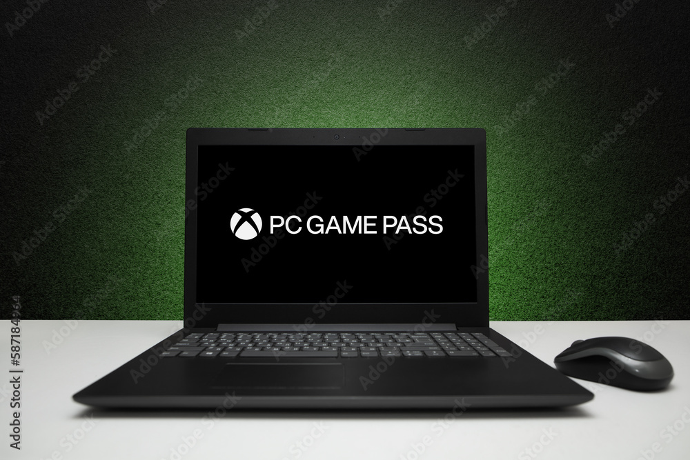 Foto de PC Game Pass logo on screen laptop computer with mouse on black ...