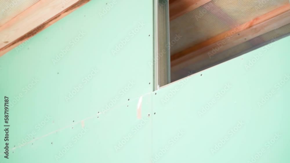 Metal U profile sheathed with drywall close-up. Moisture resistant ...