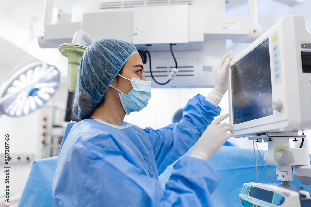 Anesthesiologist keeping track of vital functions of the body during ...