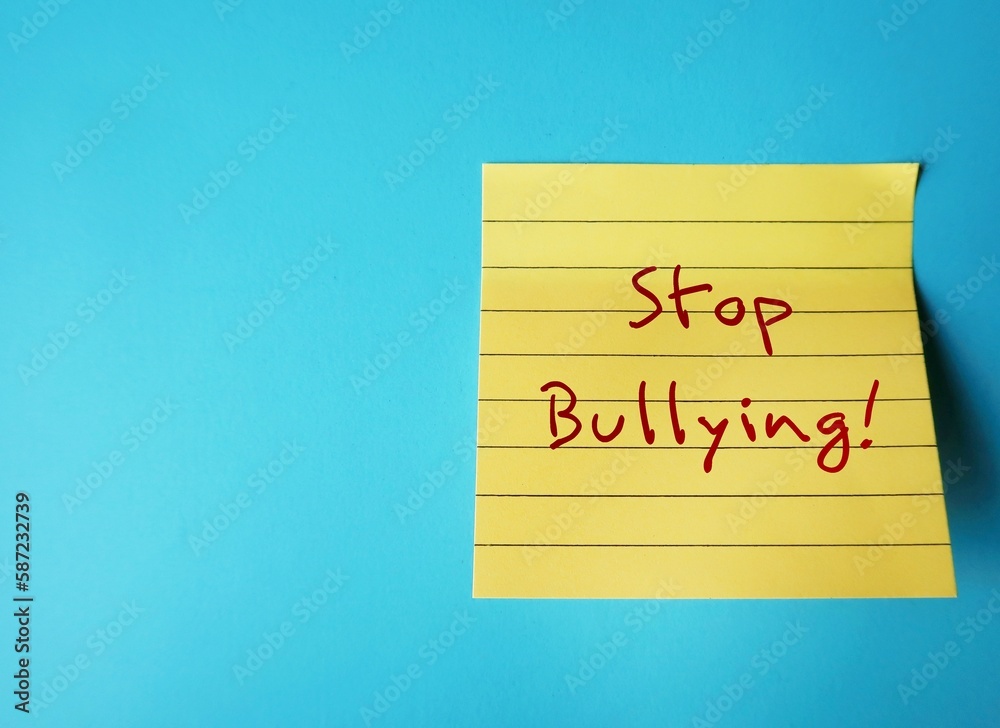 Yellow note stick on blue copy space background with handwritten text ...