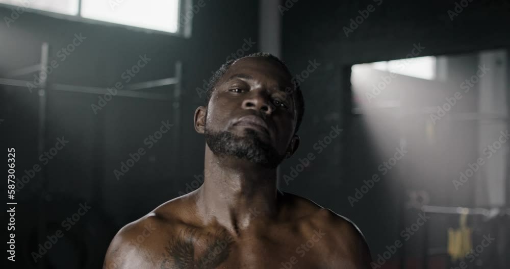 Zooming in adult African American man with tattoo on his chest raising ...