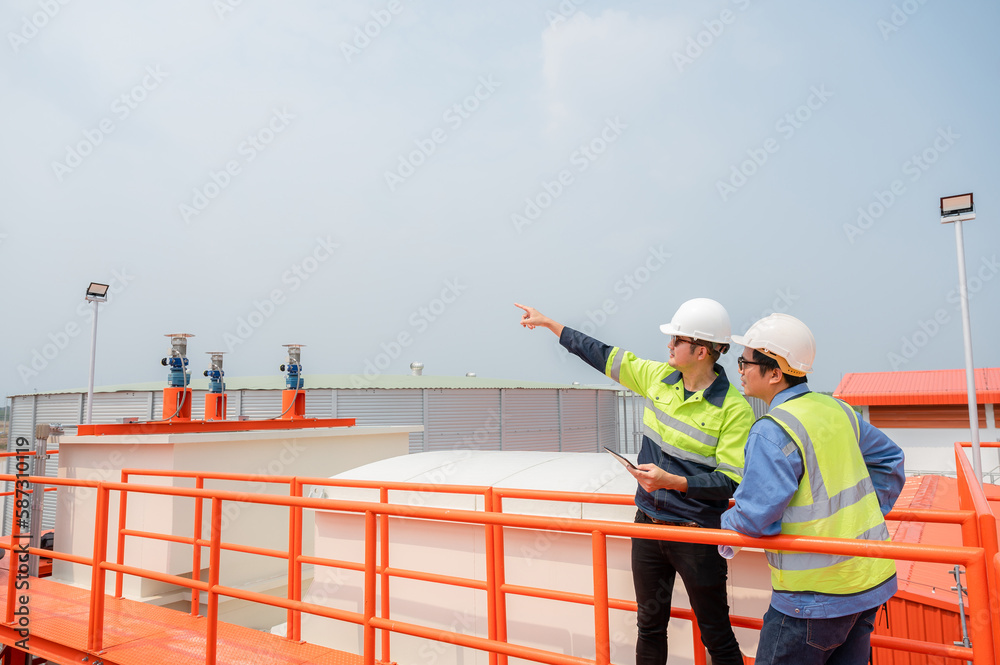 2 Asian male industrial engineers and architects Work to inspect water ...
